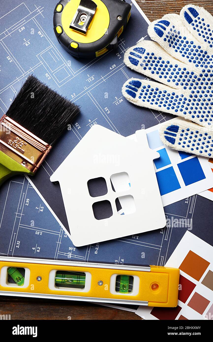 Construction instruments, plan and brushes on house plan background ...