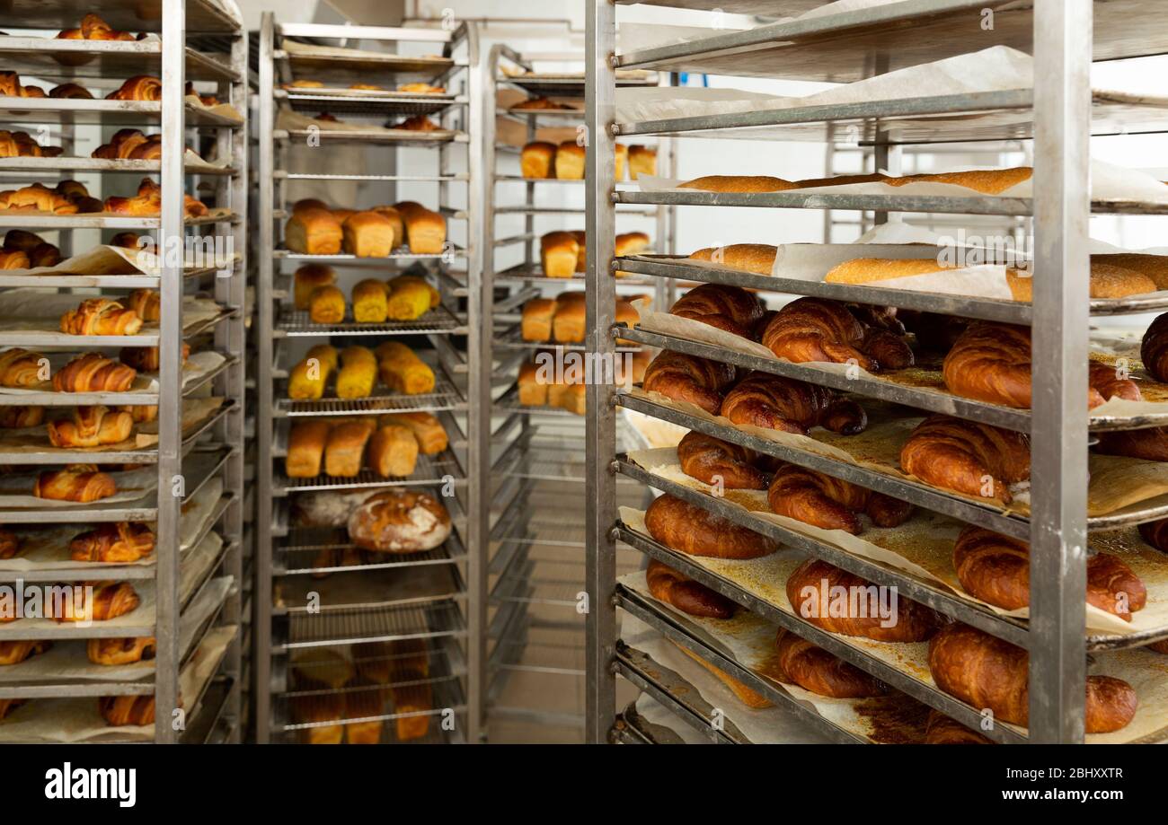 View of rack trolley with various baked bread and pastry products in ...