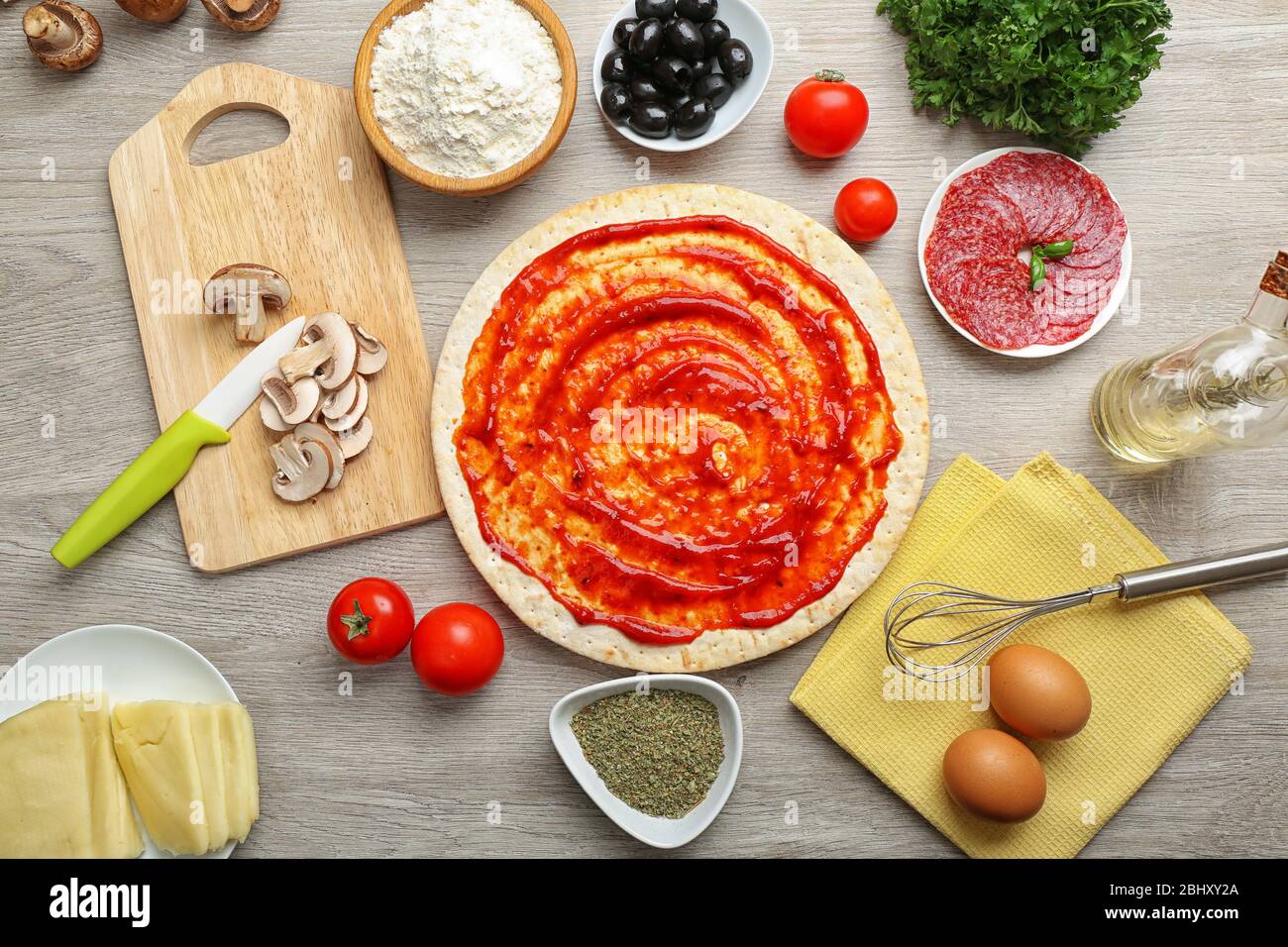 Cooking pizza on wooden table, top view Stock Photo - Alamy