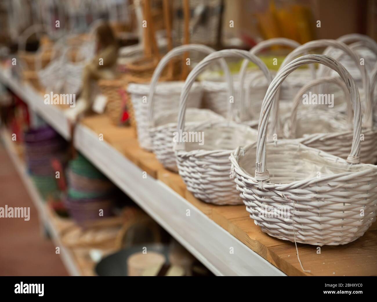 Decorative wicker baskets in store displayed on shelves in decor shop ...