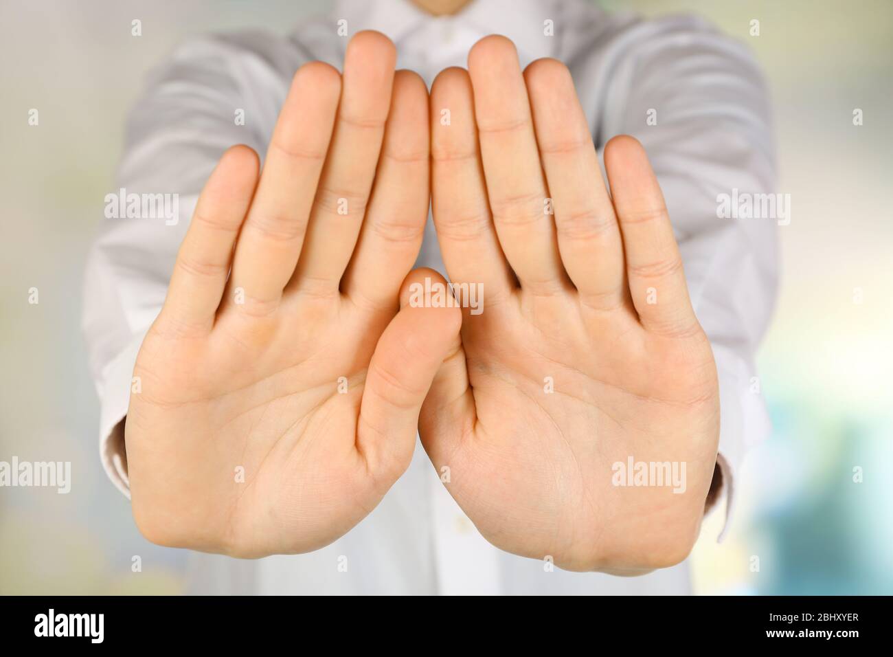 Arm with fingers showing stop sign hi-res stock photography and images ...