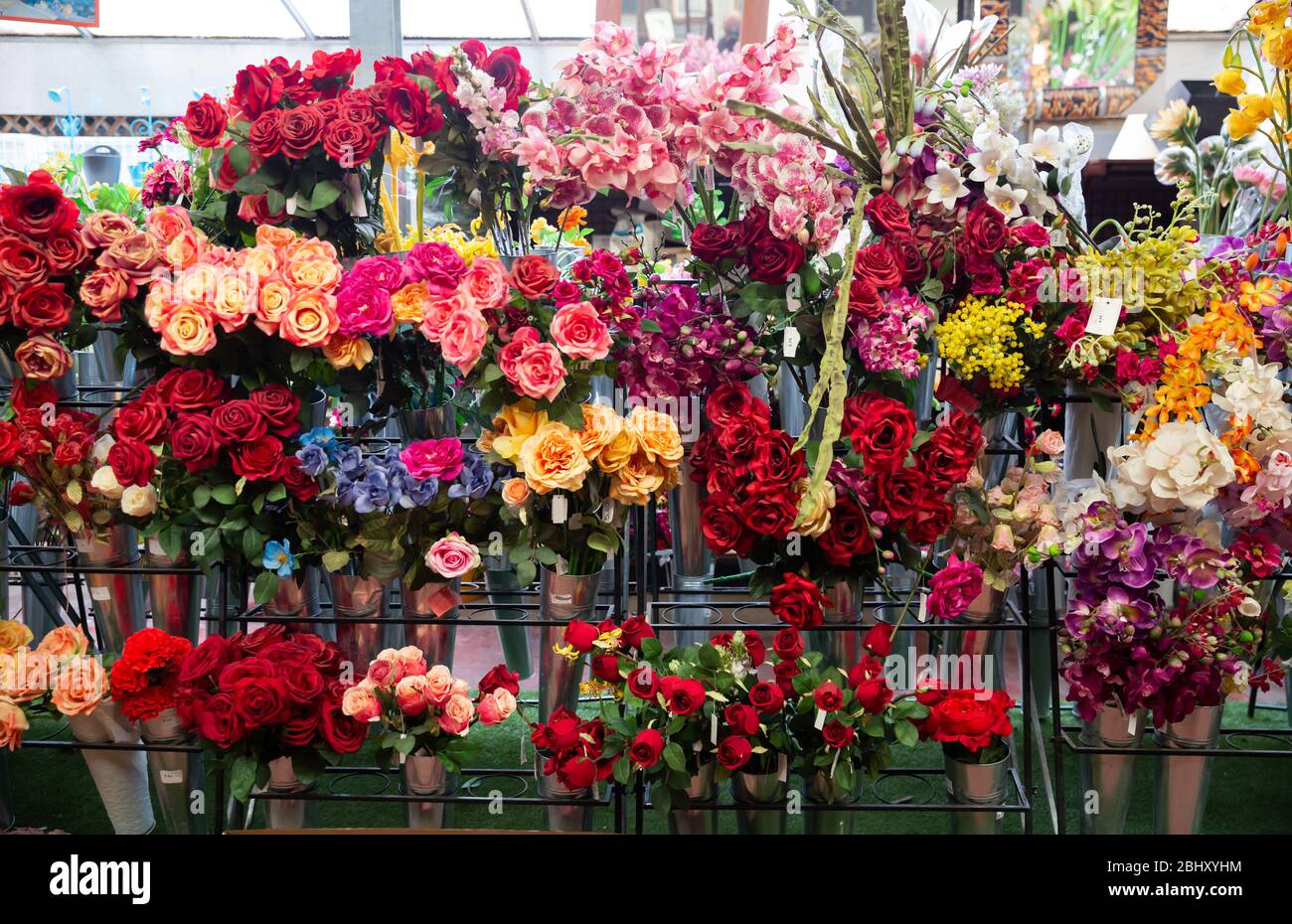 Colorful showcase of flower shop with large assortment of artificial ...