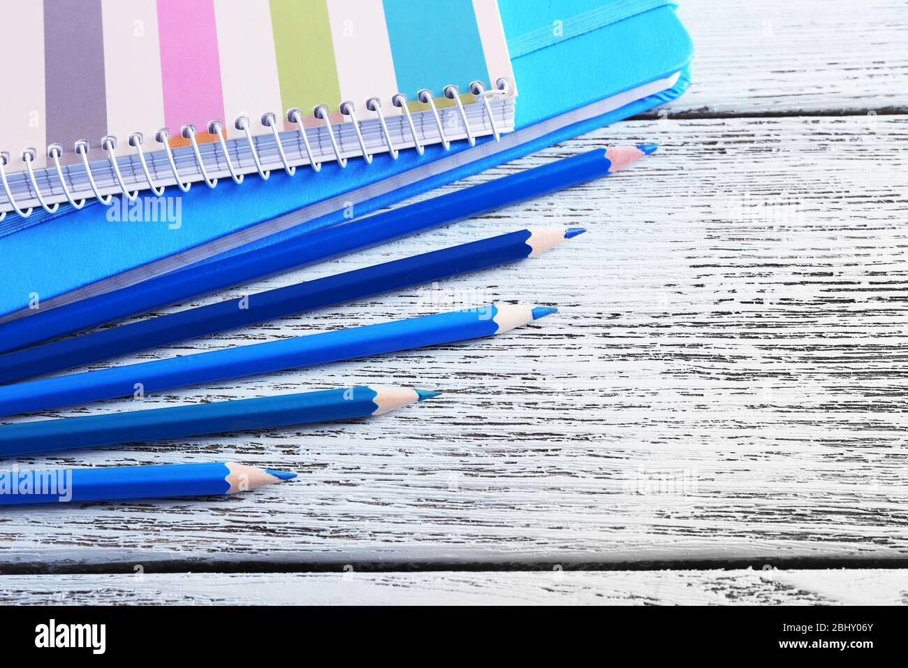 Turquoise crayons and diary on wooden table, closeup Stock Photo - Alamy