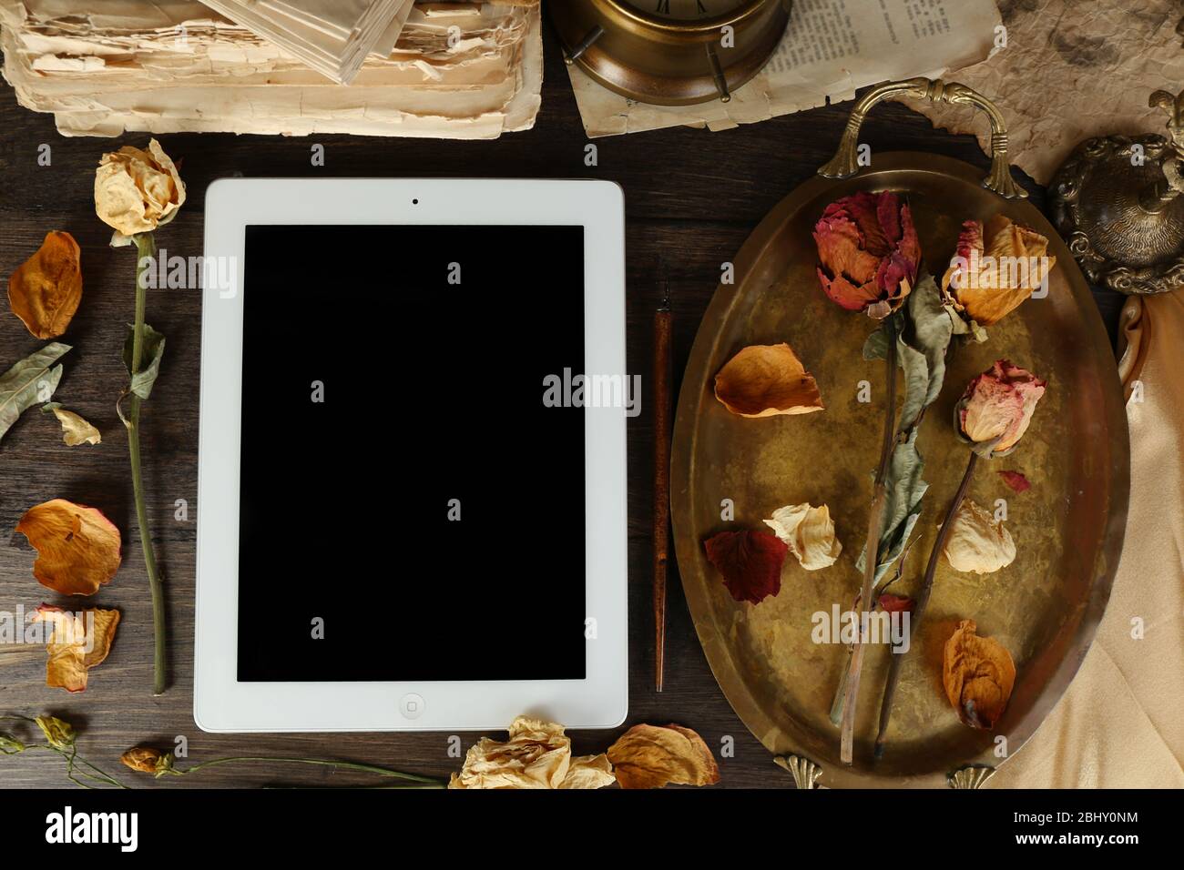 Ancient things and tablet on wooden background Stock Photo - Alamy