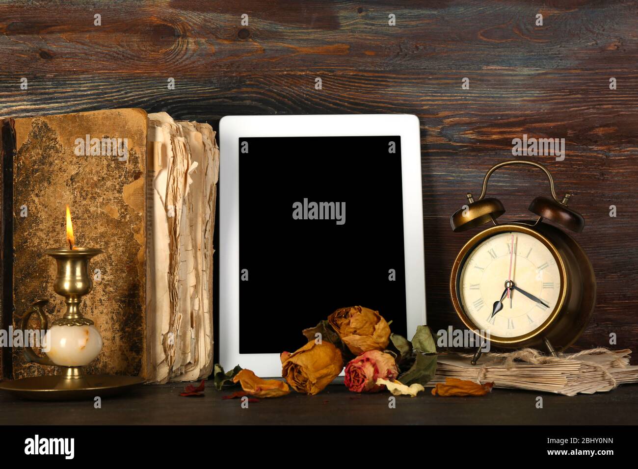 Ancient things and tablet on wooden background Stock Photo - Alamy