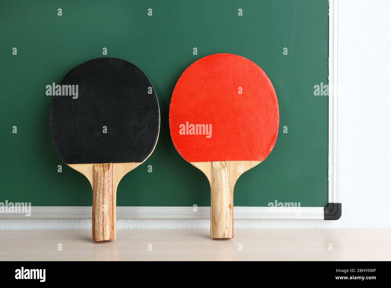 Table tennis rackets on blackboard background Stock Photo - Alamy