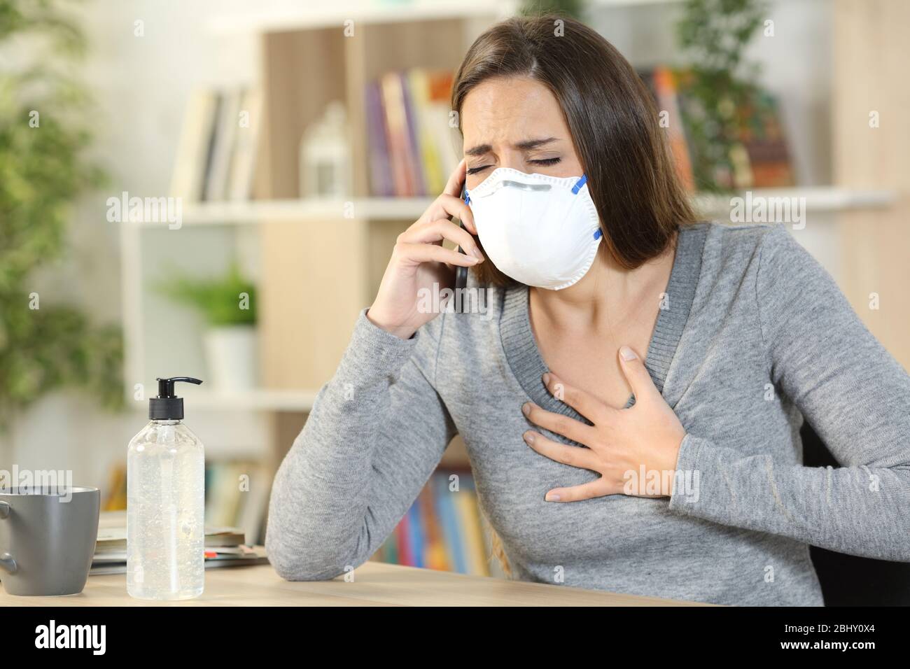 Woman sick of covid-19 suffocating with protective mask holding chest ...