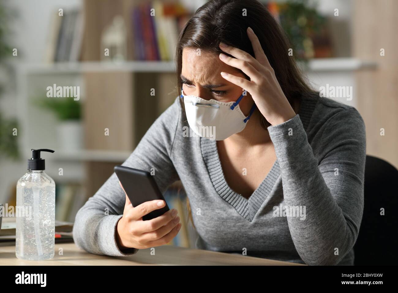 Phone mask woman message worried hi-res stock photography and images ...