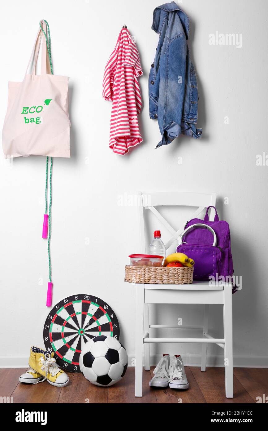 Children things hanging on wall and stacked in room Stock Photo - Alamy