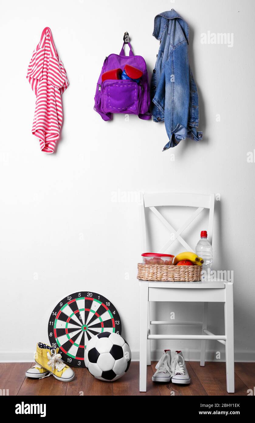 School bag hanging on hook hi-res stock photography and images - Alamy
