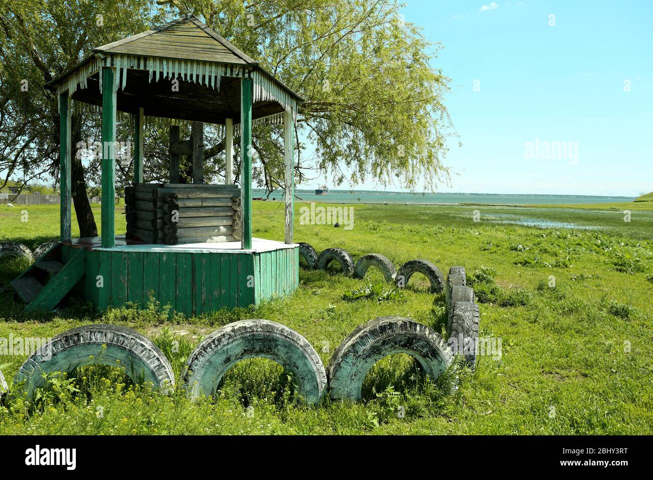 Wooden well near tree, outdoors Stock Photo - Alamy