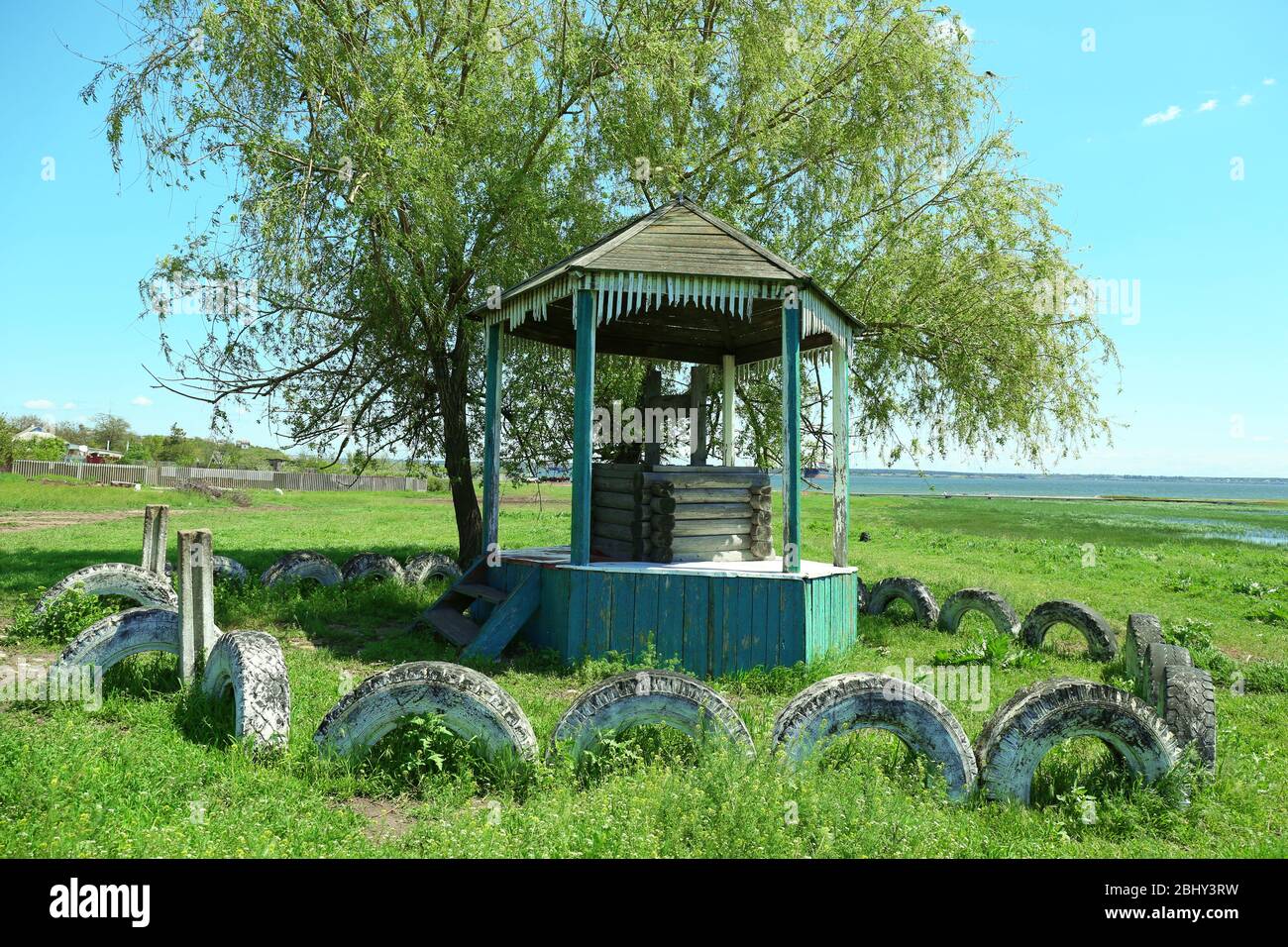 Wooden well near tree, outdoors Stock Photo - Alamy