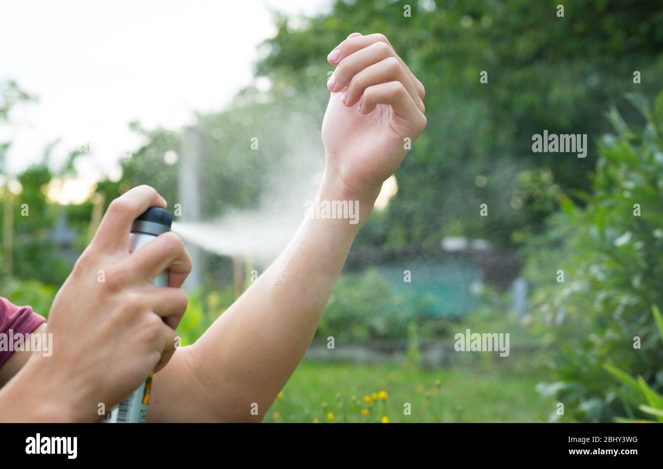 Young man spraying mosquito, insect repellent in the forrest, insect ...