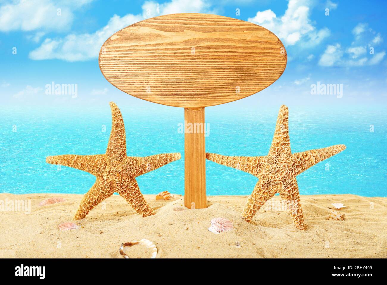 Wooden signboard with sand on sea background Stock Photo - Alamy