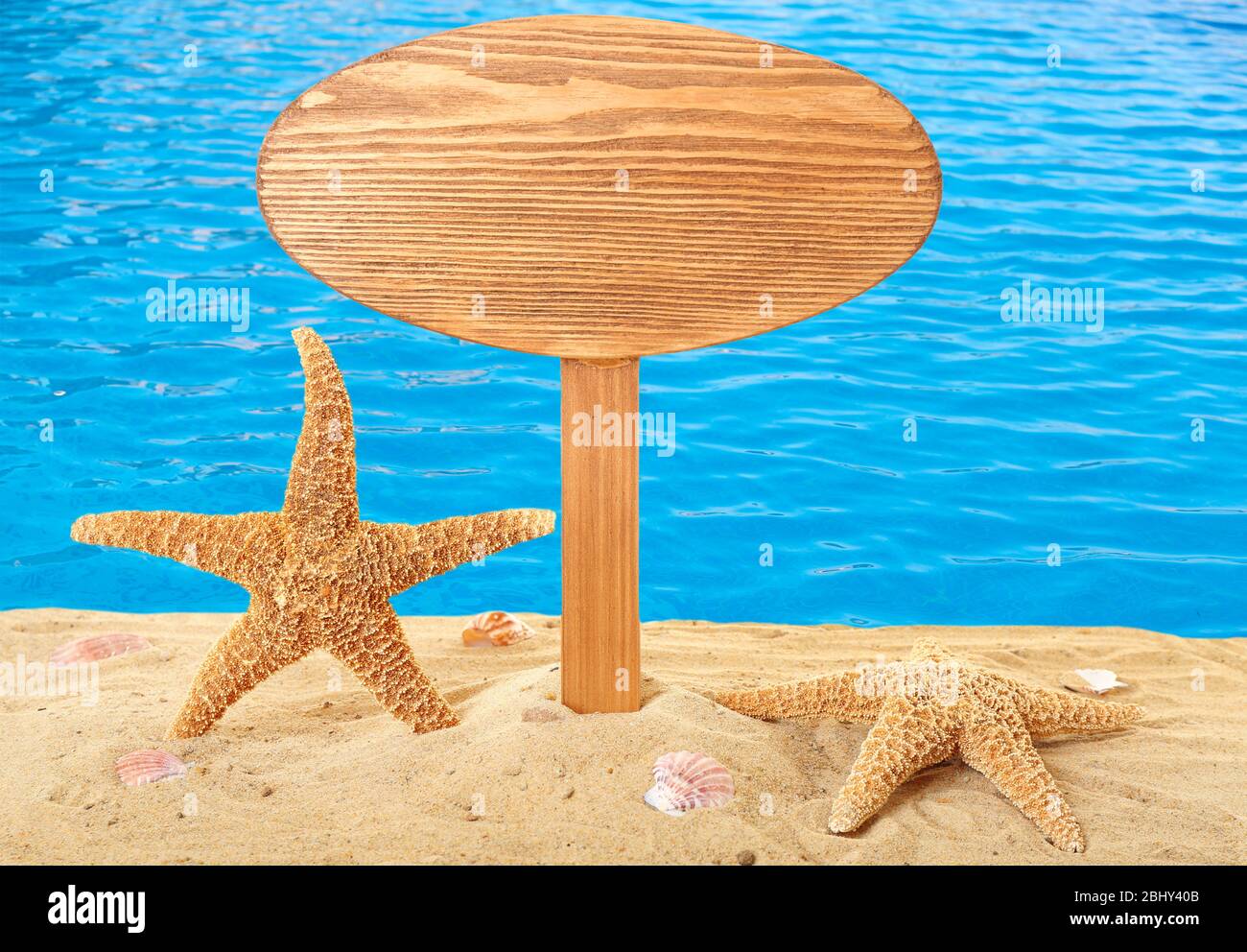 Wooden signboard with sand on sea background Stock Photo - Alamy