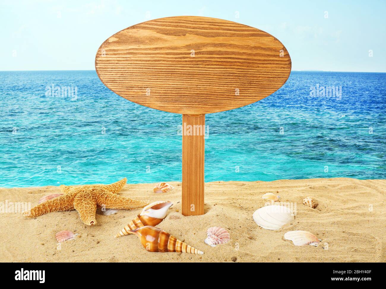 Wooden signboard with sand on sea background Stock Photo - Alamy