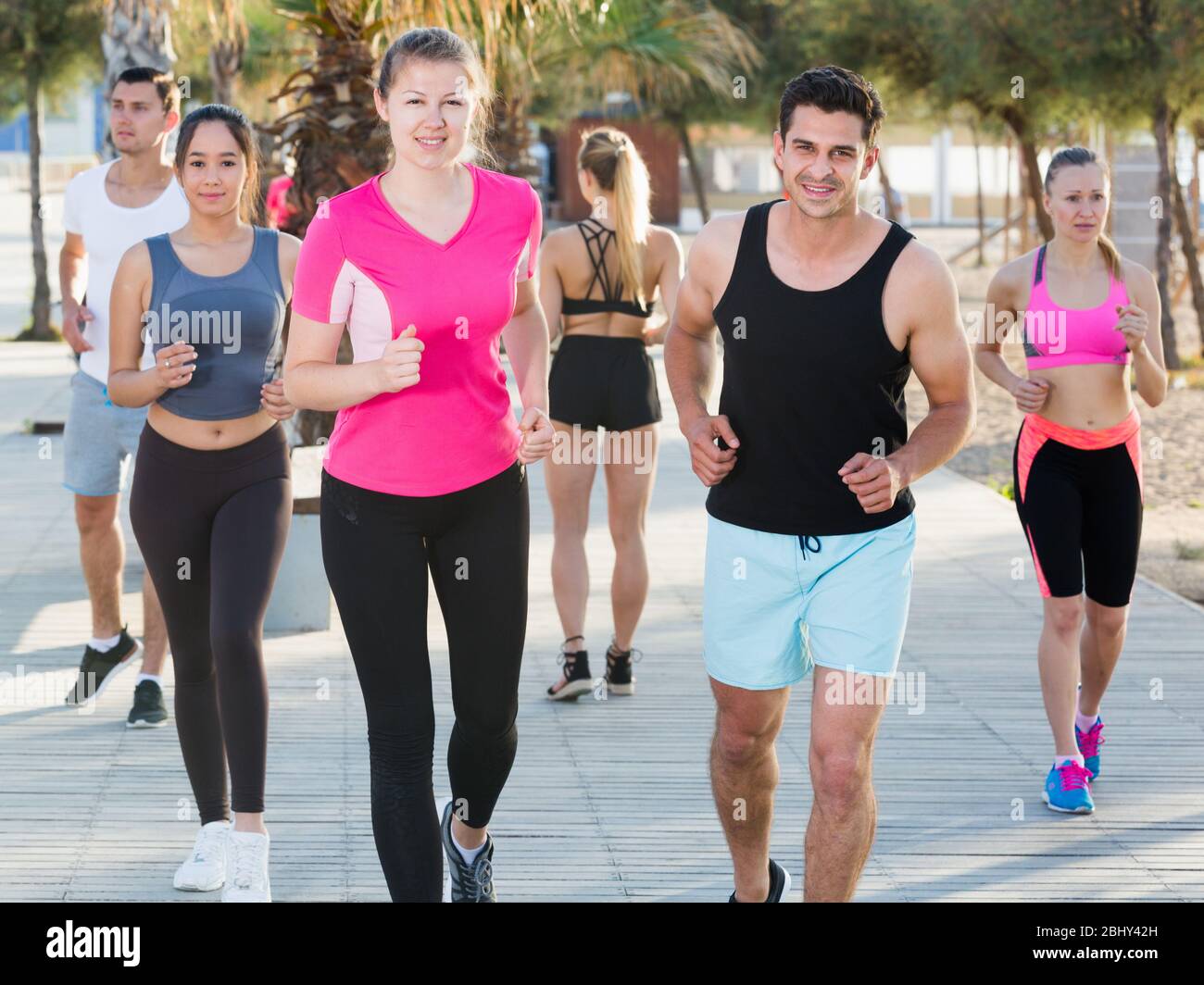 Active smiling people during running training in daytime Stock Photo ...