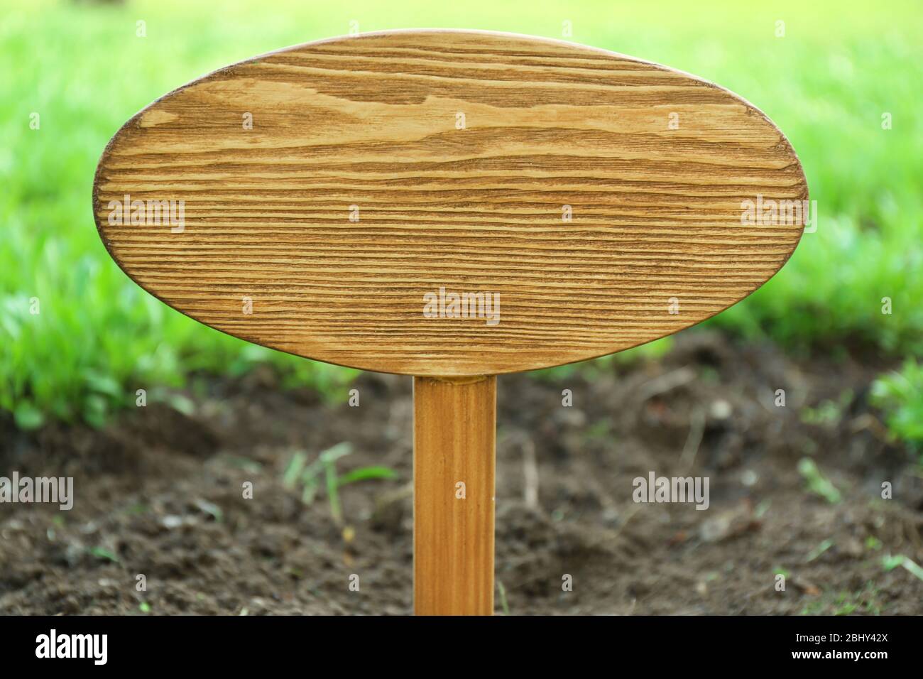 Wooden signboard over grass, outdoors Stock Photo - Alamy
