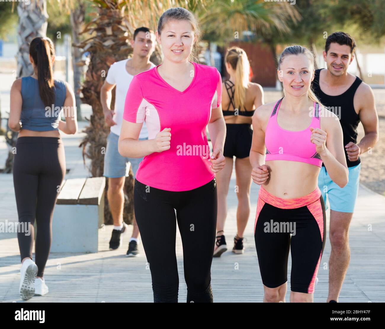 Active smiling people during running training in daytime Stock Photo ...