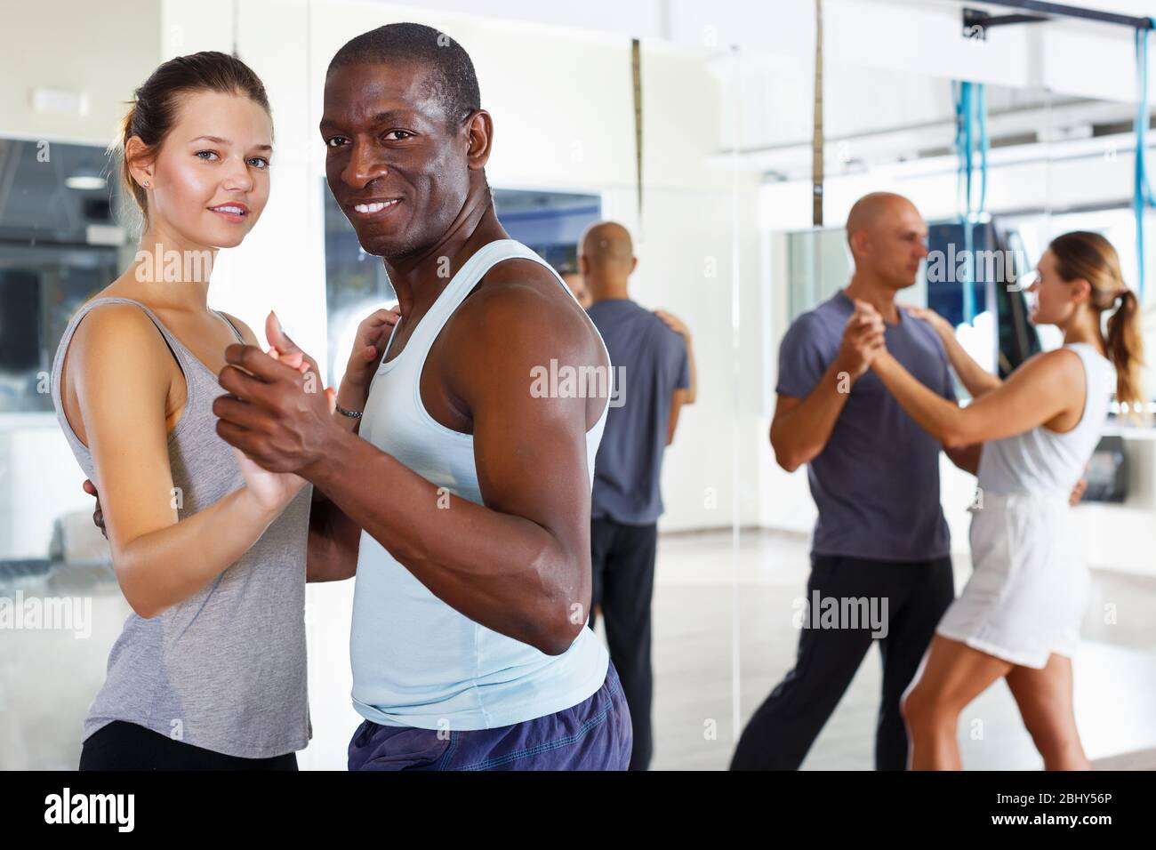 happy dancing couples enjoying slow foxtrot in dance studio Stock Photo ...