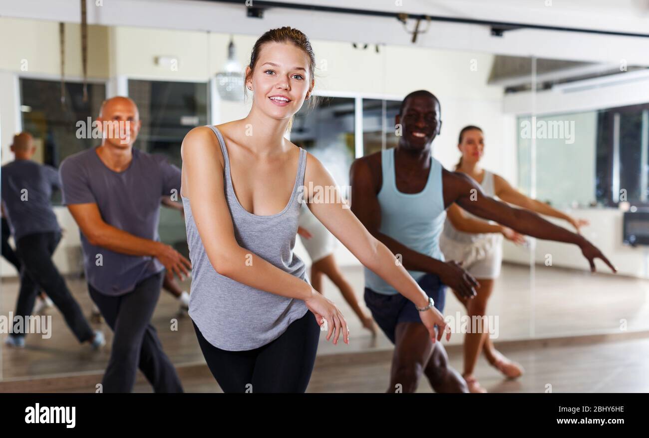happy active young dancing people practicing vigorous swing in dance ...