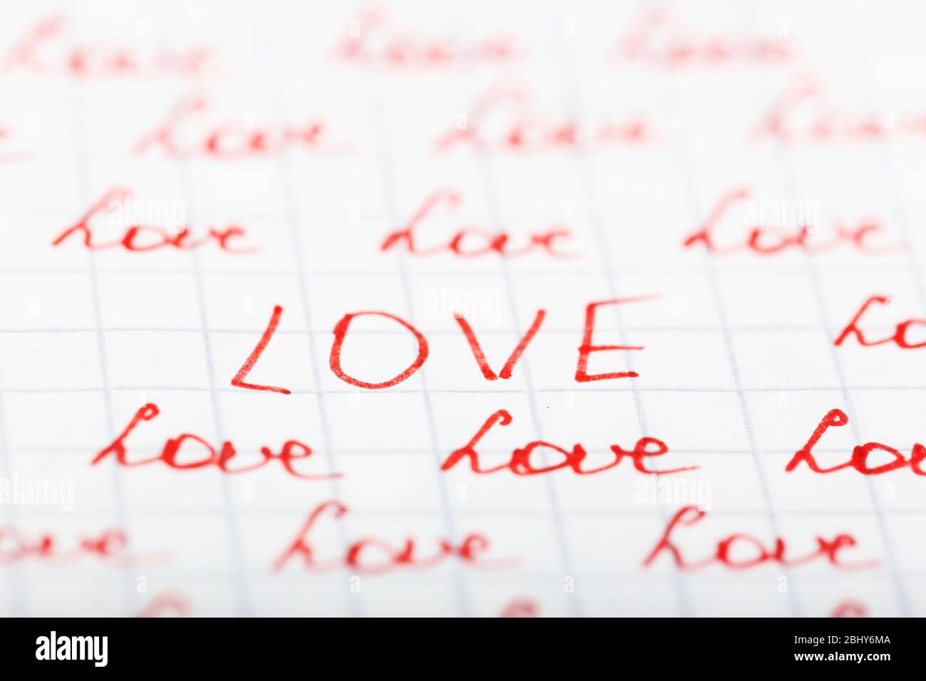 Words LOVE written on sheet of paper background Stock Photo - Alamy