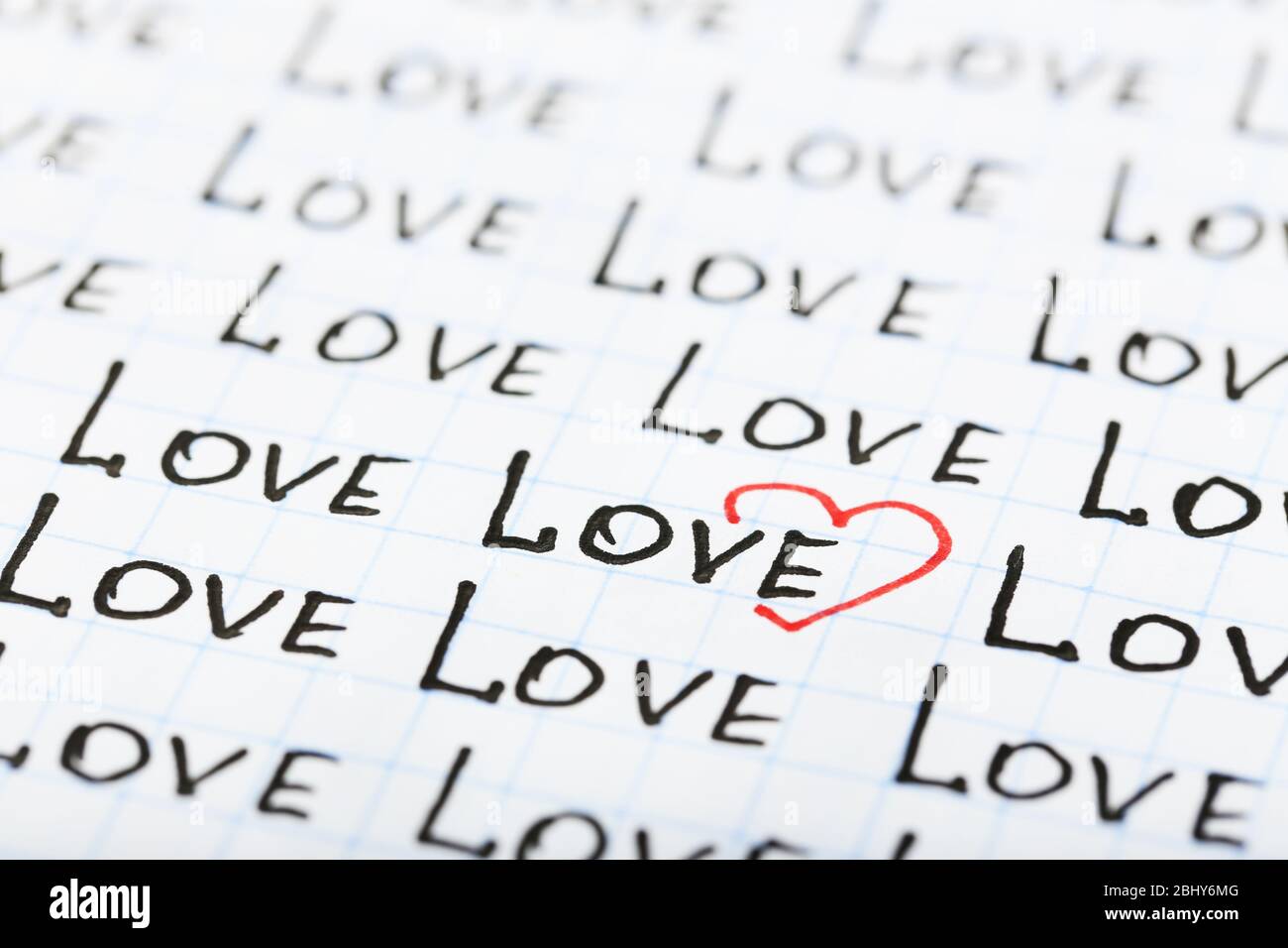 Words LOVE written on sheet of paper background Stock Photo - Alamy