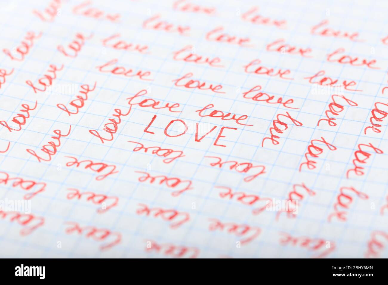 Words LOVE written on sheet of paper background Stock Photo - Alamy