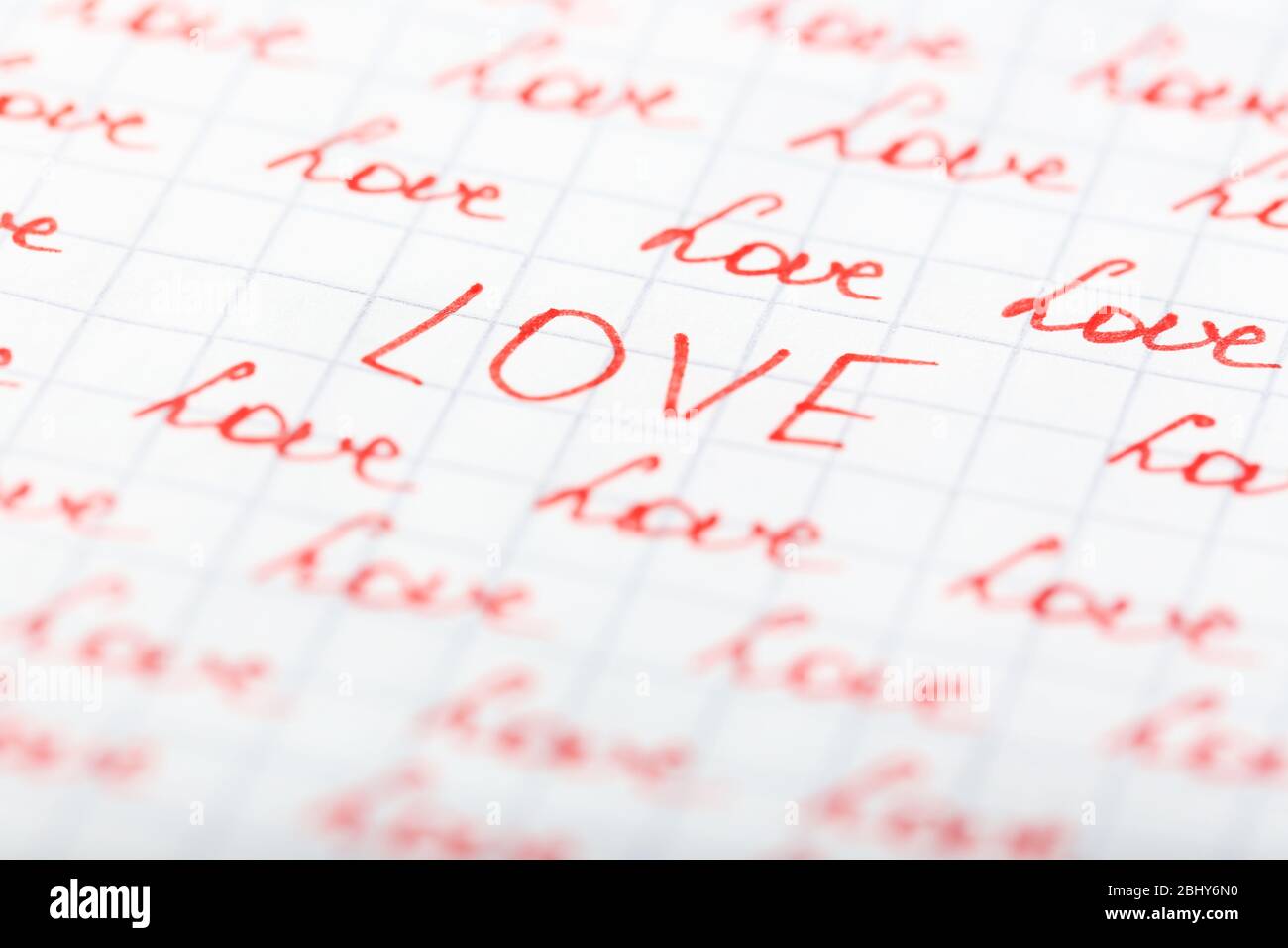Words LOVE written on sheet of paper background Stock Photo - Alamy