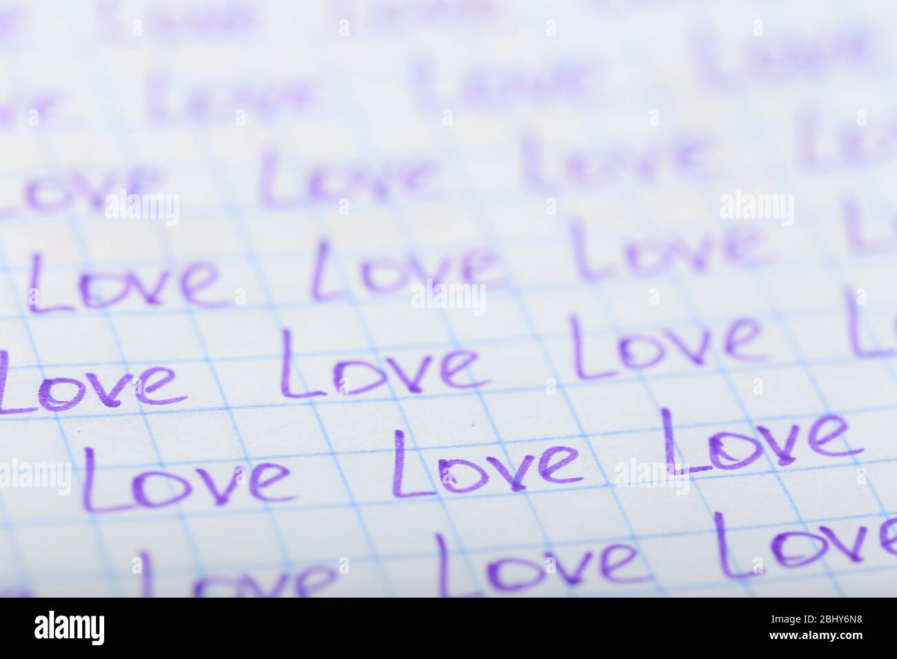 Words LOVE written on sheet of paper background Stock Photo - Alamy