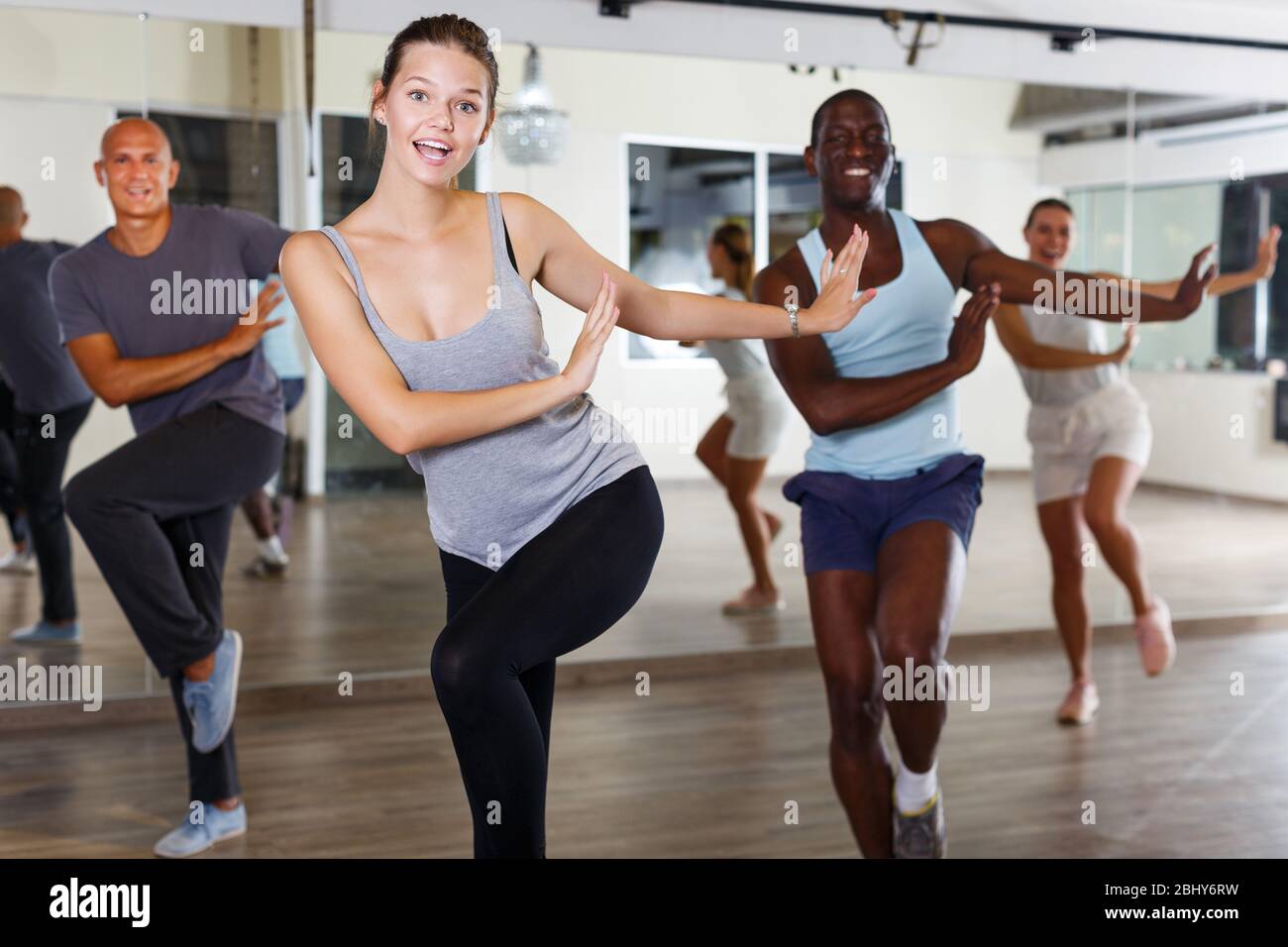 glad dancing people practicing vigorous swing in dance studio Stock ...