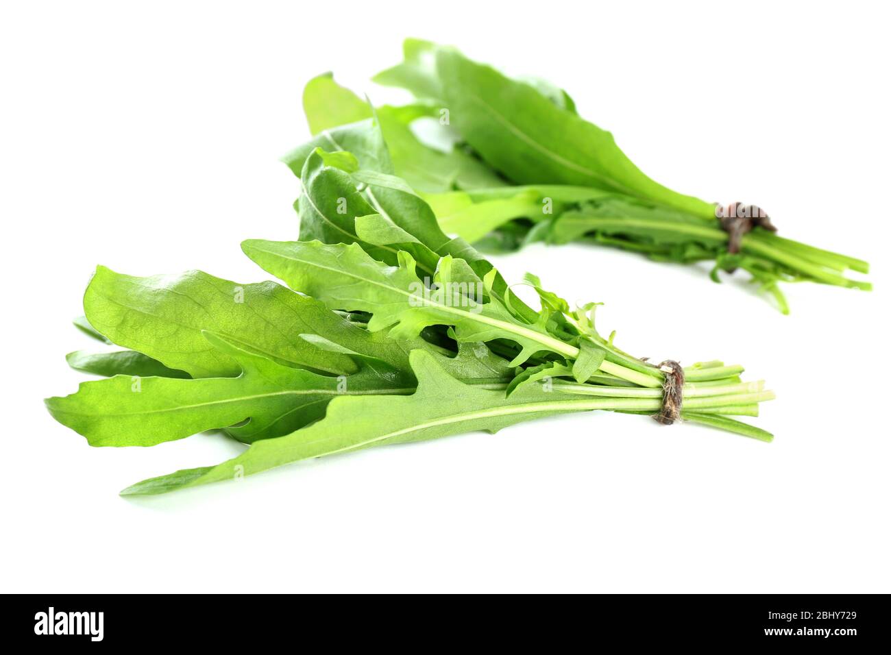 Bunch of fresh arugula leaves isolated on white Stock Photo - Alamy