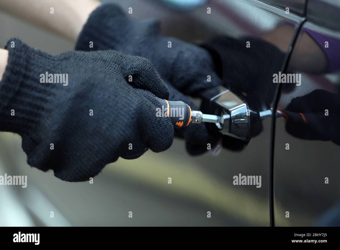 Man burglar stealing car Stock Photo - Alamy