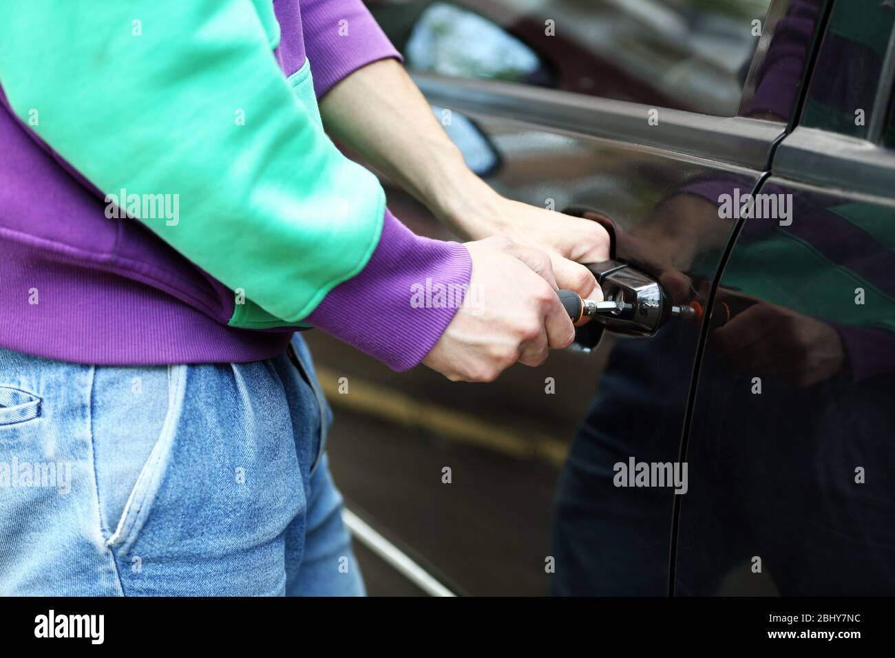 Man burglar stealing car Stock Photo - Alamy