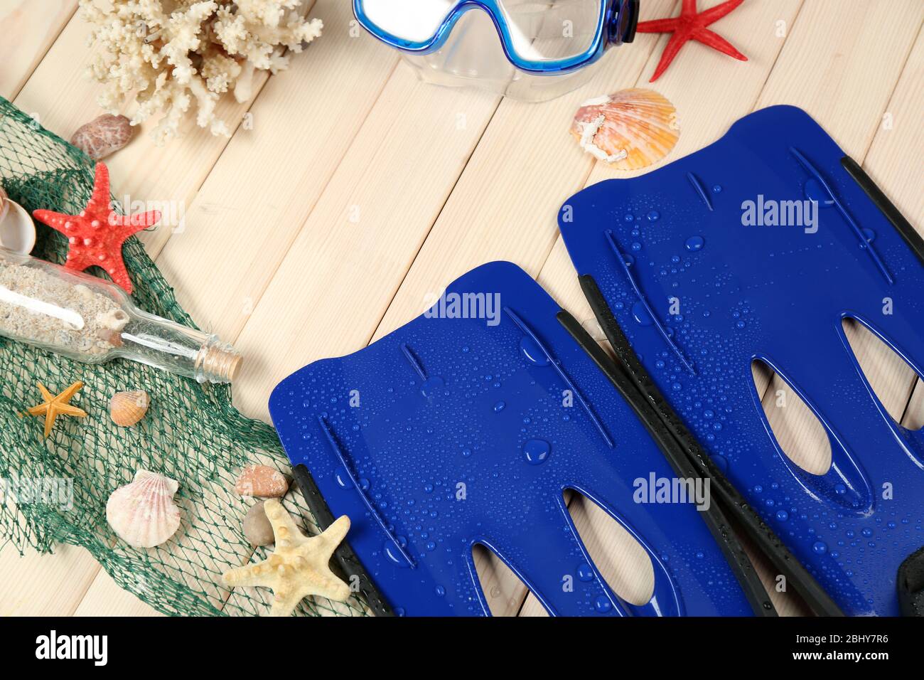 Sea composition with flippers and shells on wooden table close up Stock ...
