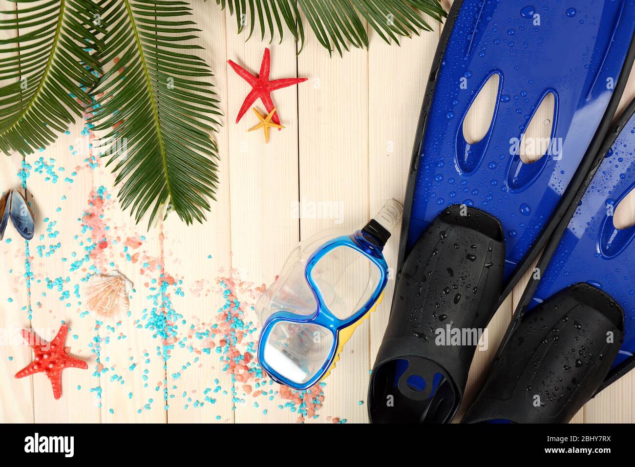 Sea composition with flippers and shells on wooden table close up Stock ...