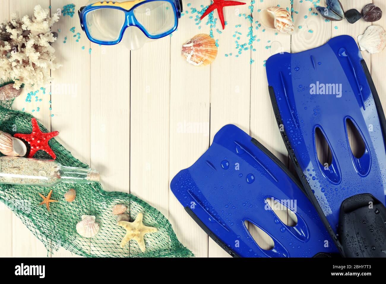 Sea composition with flippers and shells on wooden table close up Stock ...