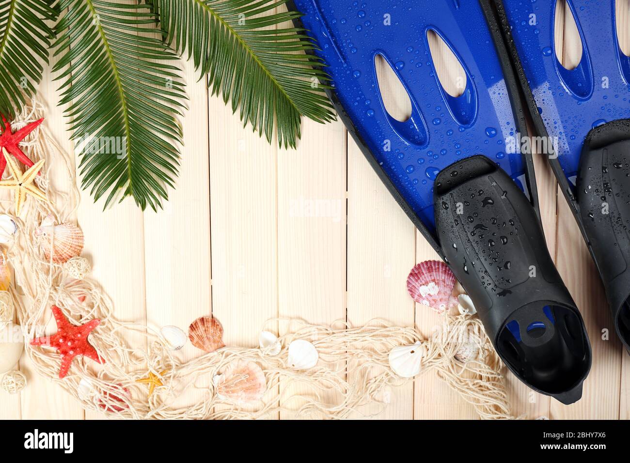 Sea composition with flippers and shells on wooden table close up Stock ...