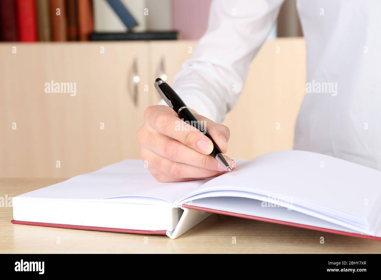 Hand write on notebook in office Stock Photo - Alamy