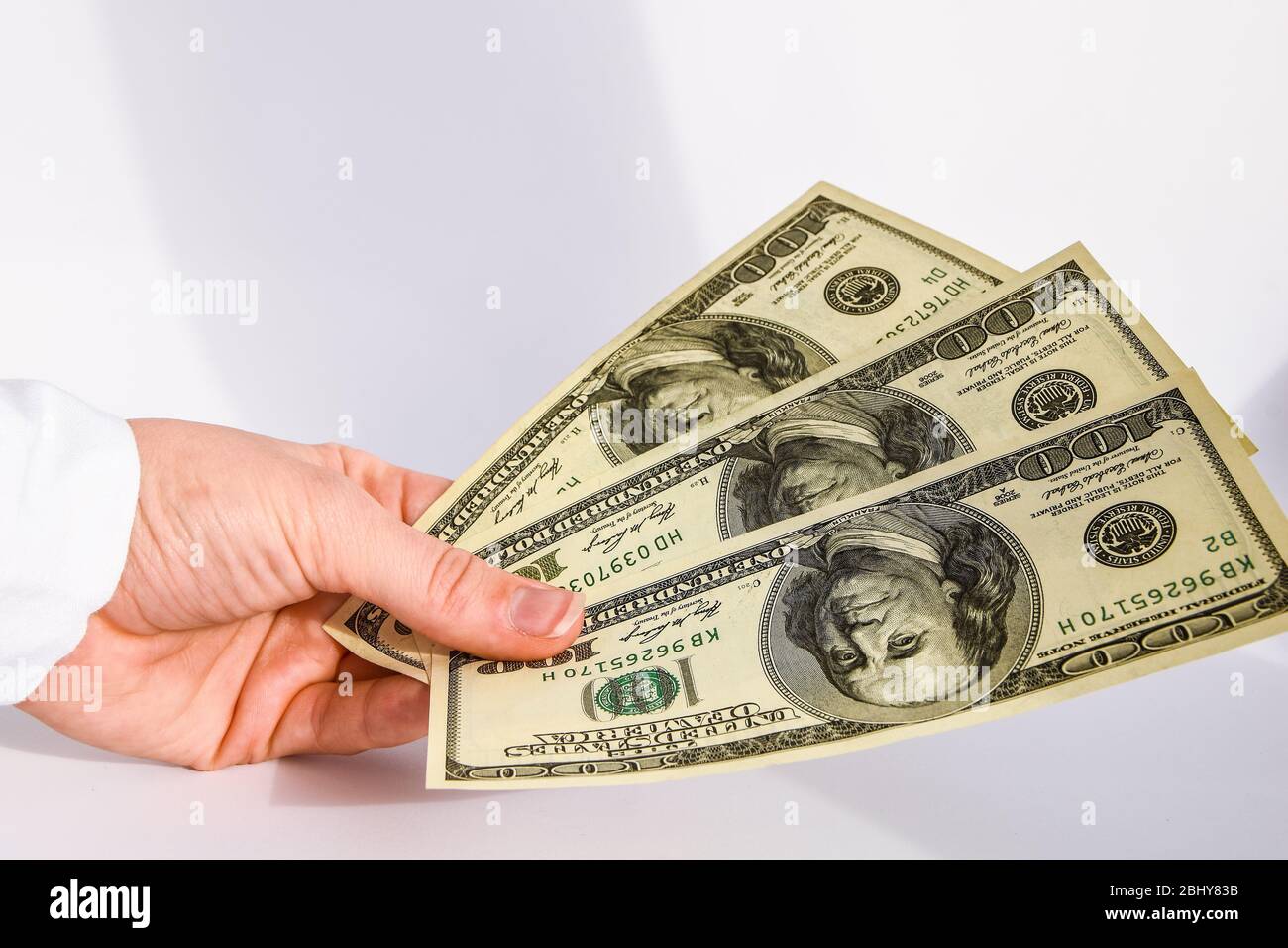 dollar currency, hand holding dollars cash on the black background ...