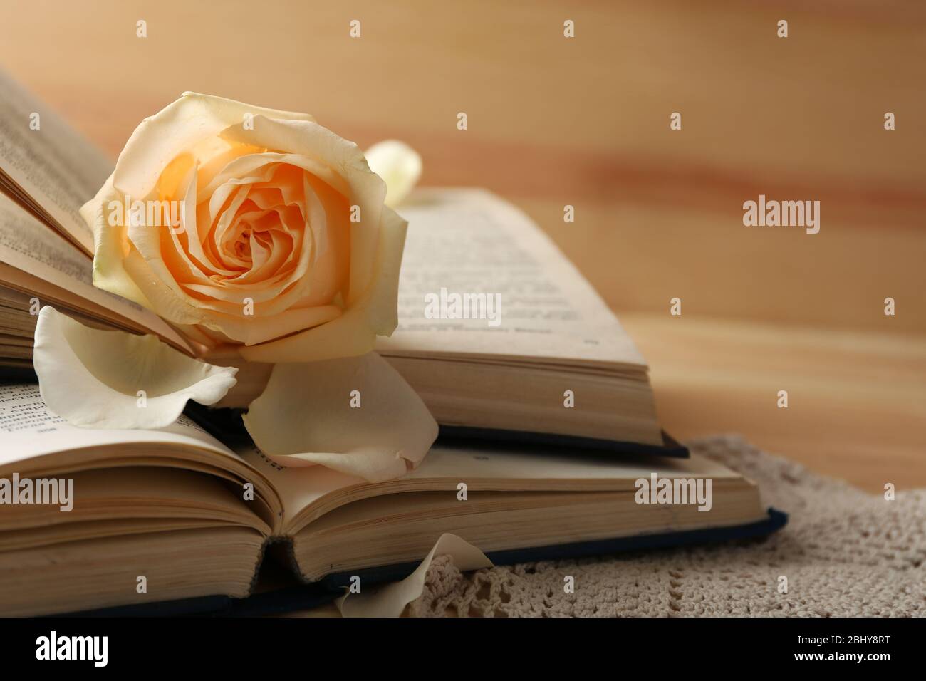 Fresh roses with old books on wooden background. Vintage concept Stock ...