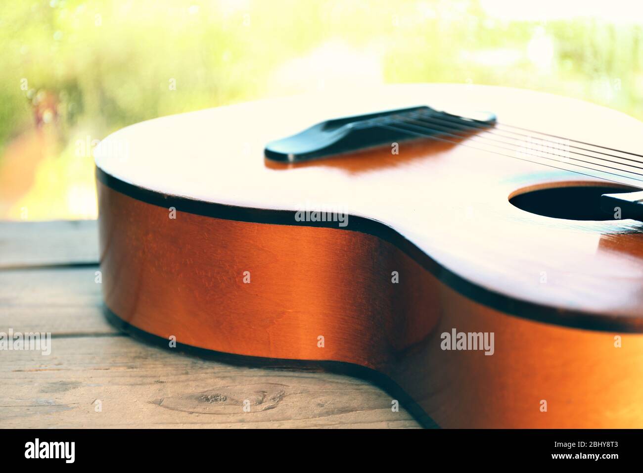 Acoustic guitar next the window with rain drops Stock Photo - Alamy
