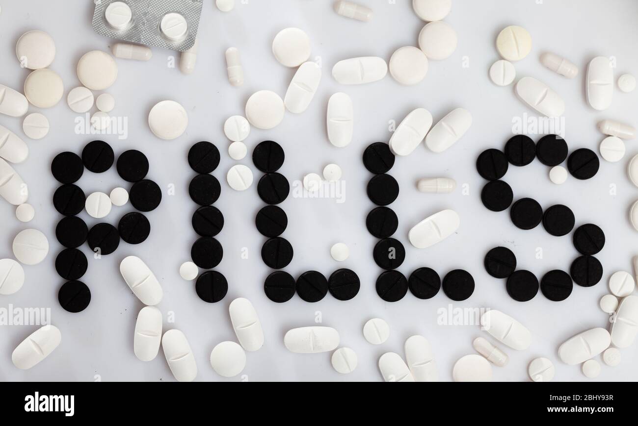 Word PILLS made of assorted pharmaceutical medicine pills, tablets and ...