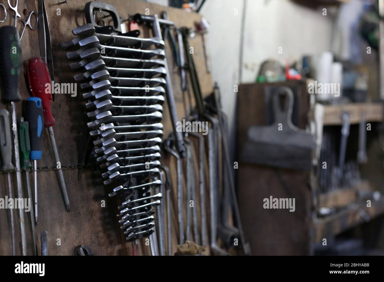 Different tools on workplace in garage Stock Photo - Alamy