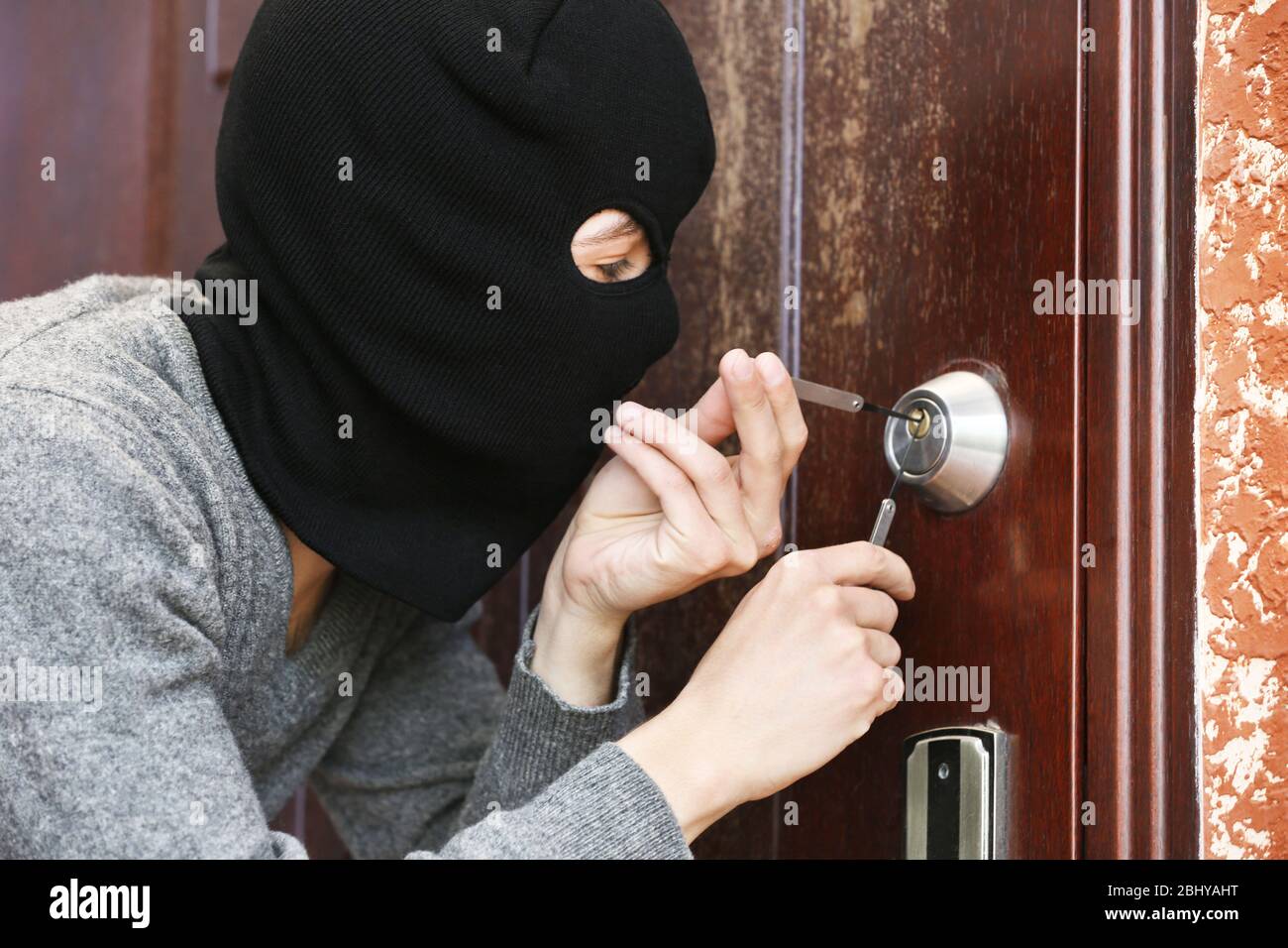 Burglar breaking into house Stock Photo - Alamy