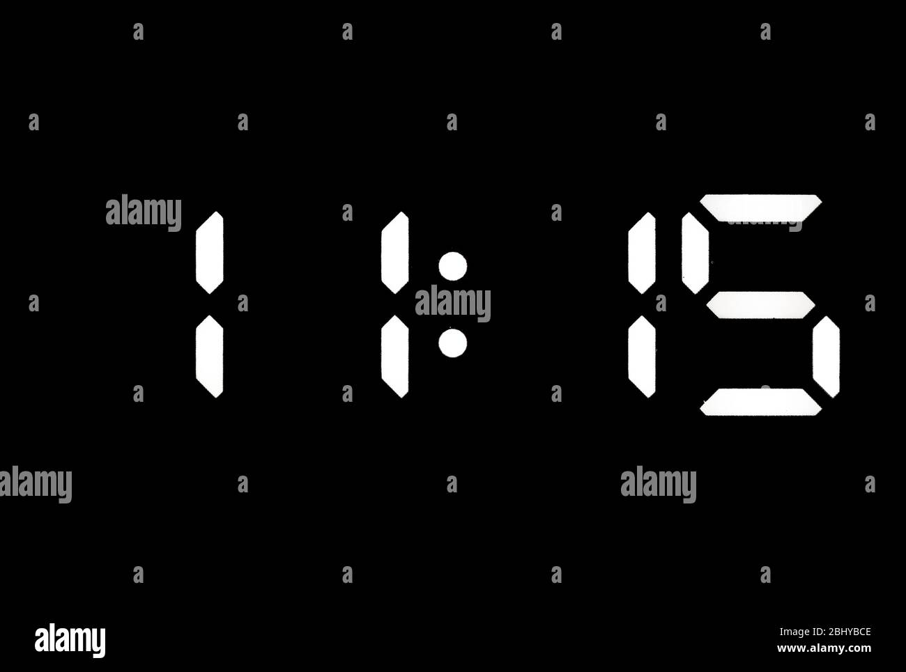 Real white led digital clock on a black background showing time 11:15 ...