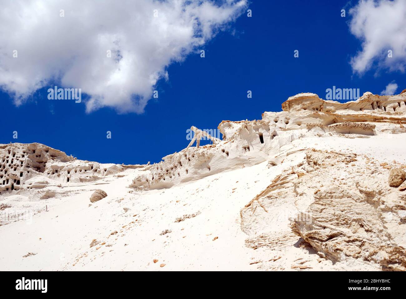 Sculptures from sand against a slope of sandy mountain Stock Photo - Alamy