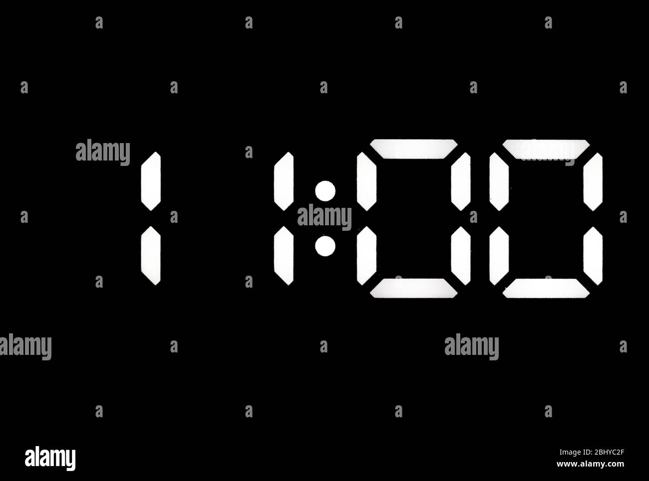 Real white led digital clock on a black background showing time 11:00 ...