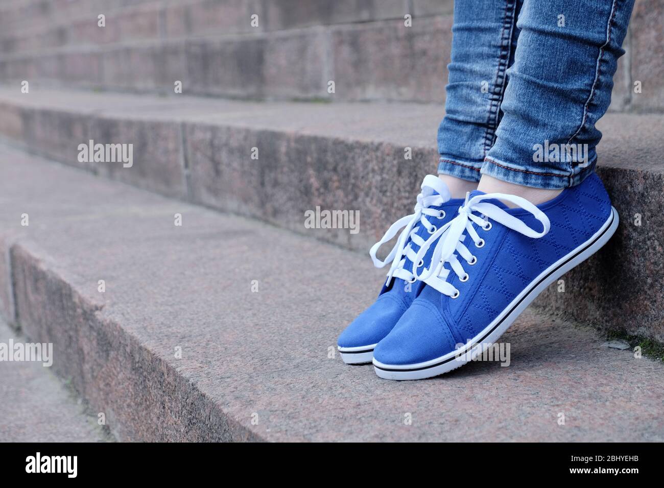 Female feet in gumshoes on stone stairs Stock Photo - Alamy