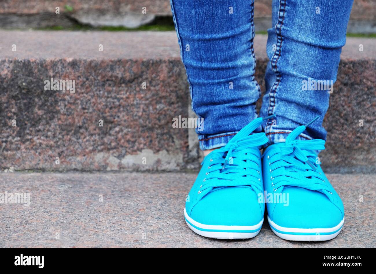 Female feet in gumshoes on stone stairs Stock Photo - Alamy